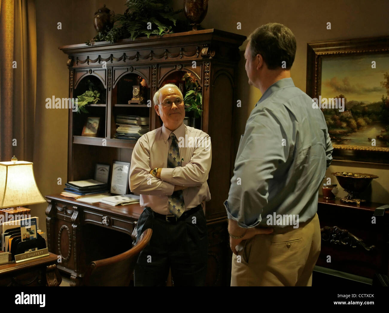 Forcht Bank branch president JOE SHUFFETT (left) discusses the loan ...