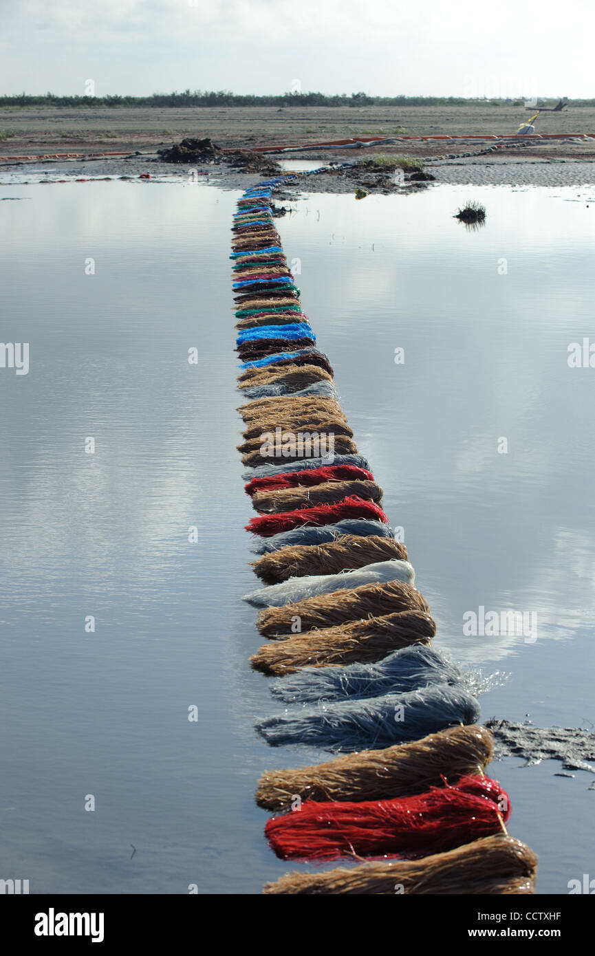 Various types of oil boom used to keep oil out of the marsh behind the ...