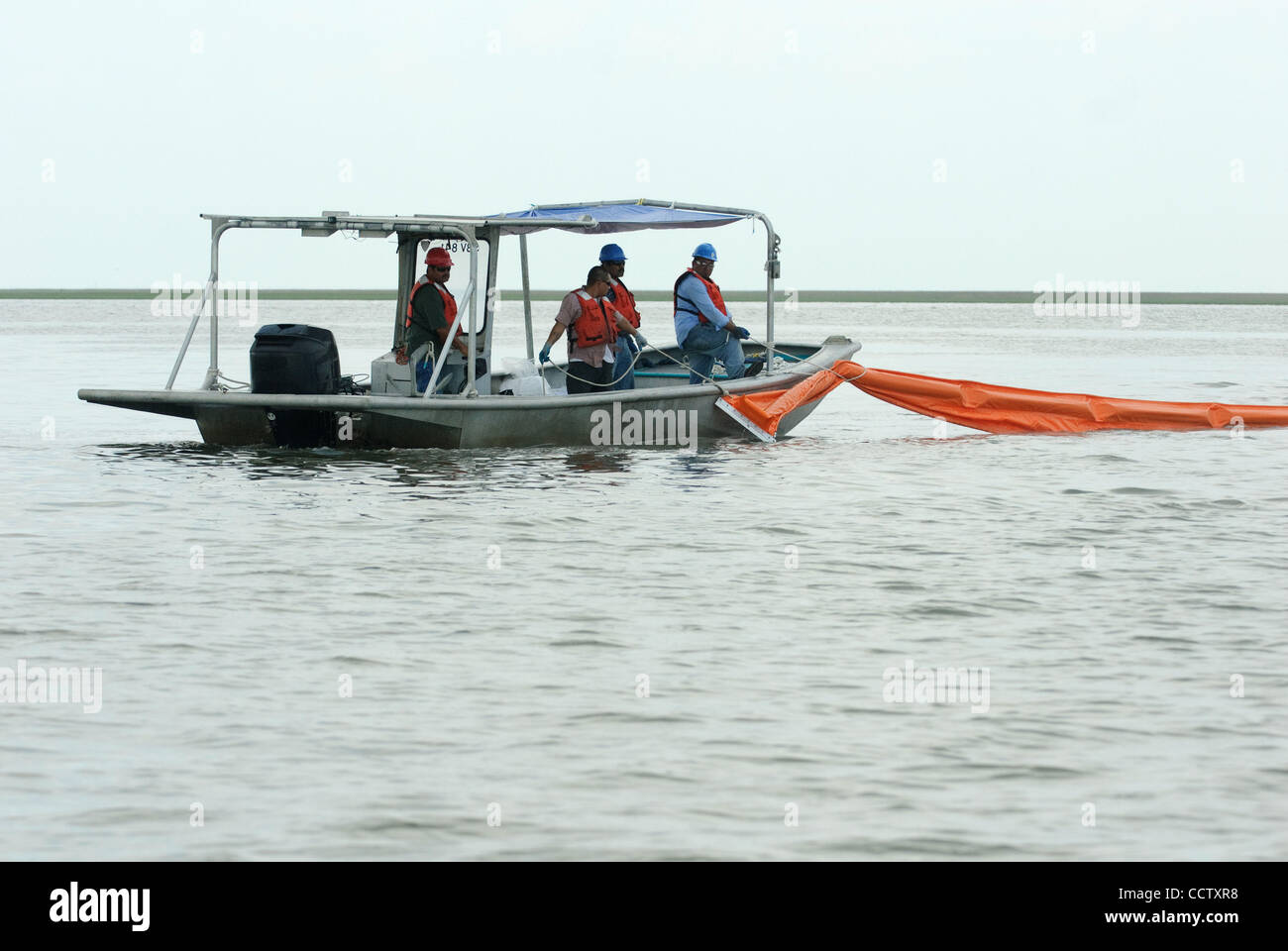 Crews set up hard boom to keep more oil from getting into the passes of ...