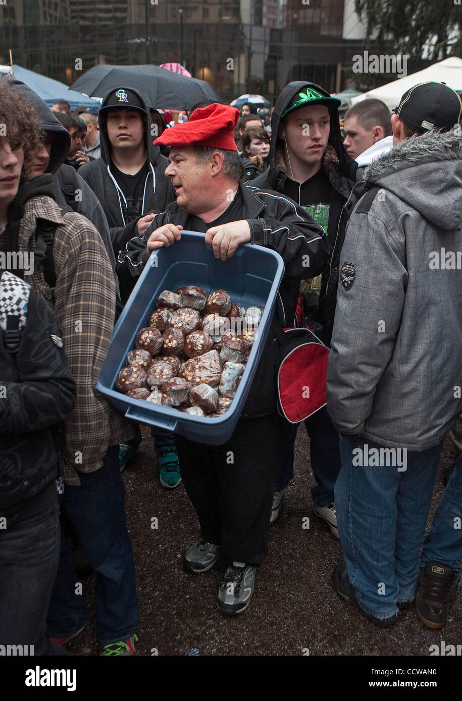A man selling muffins walks through the crowd of several thousand ...