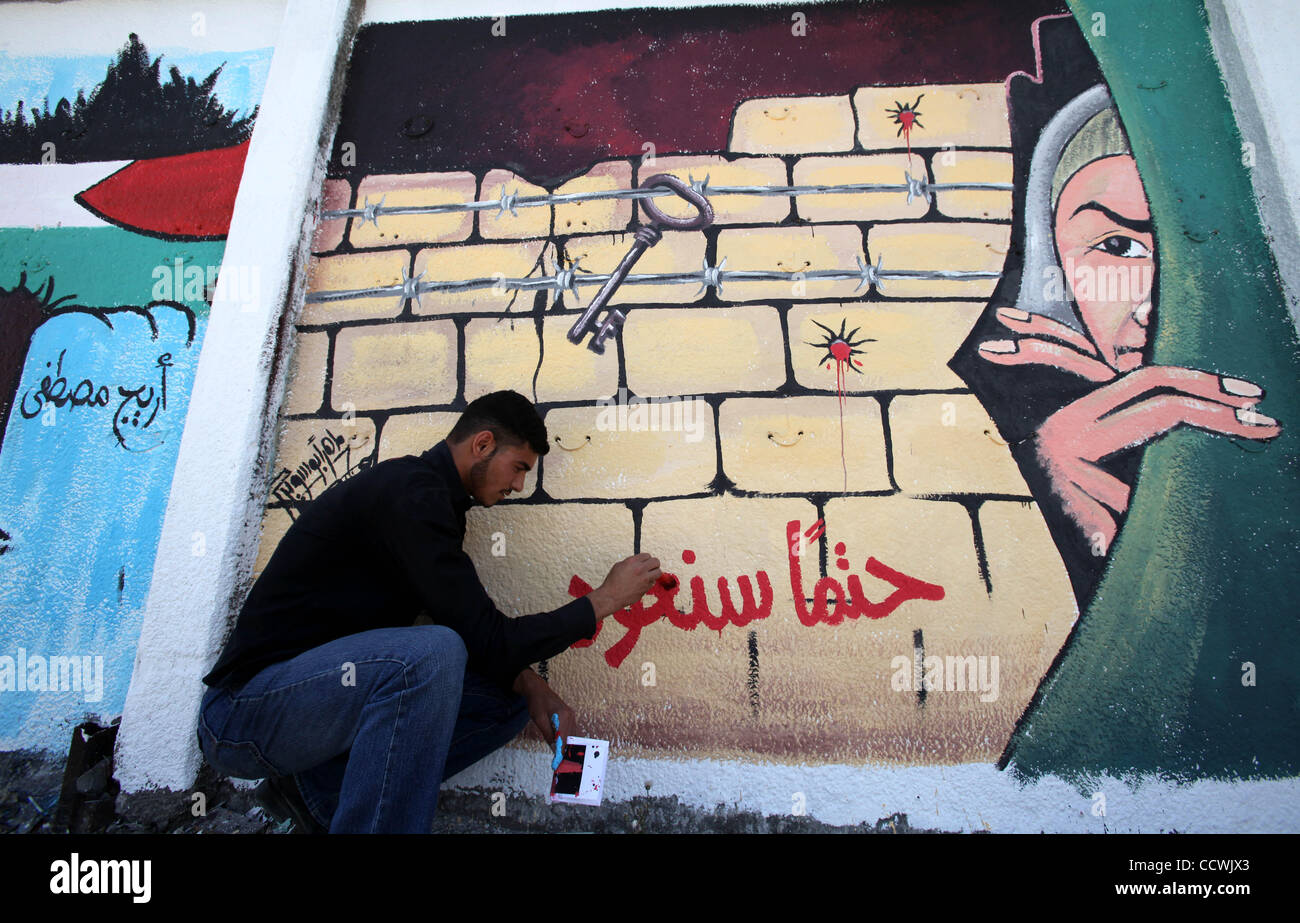 May 08, 2010 - Gaza City, Gaza Strip - A Palestinian artist puts the ...
