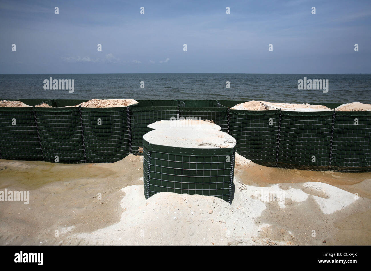 Sand barriers, anchored in place with rebar and canvas, built by ...