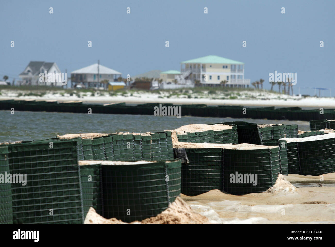 Sand barriers, anchored in place with rebar and canvas, built by ...