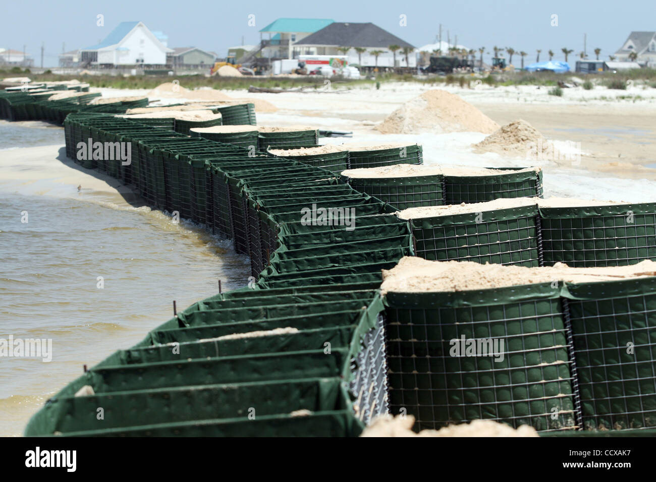 Sand barriers, anchored in place with rebar and canvas, built by ...