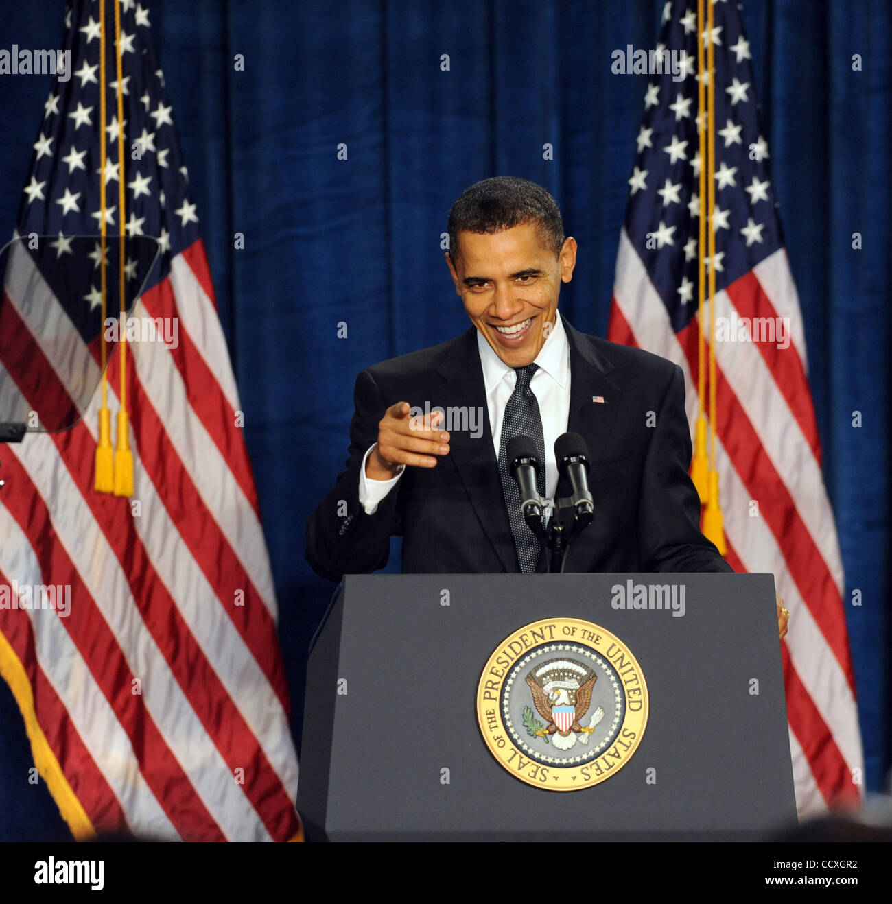 US President Barack Obama points to the crowd before speaking about ...
