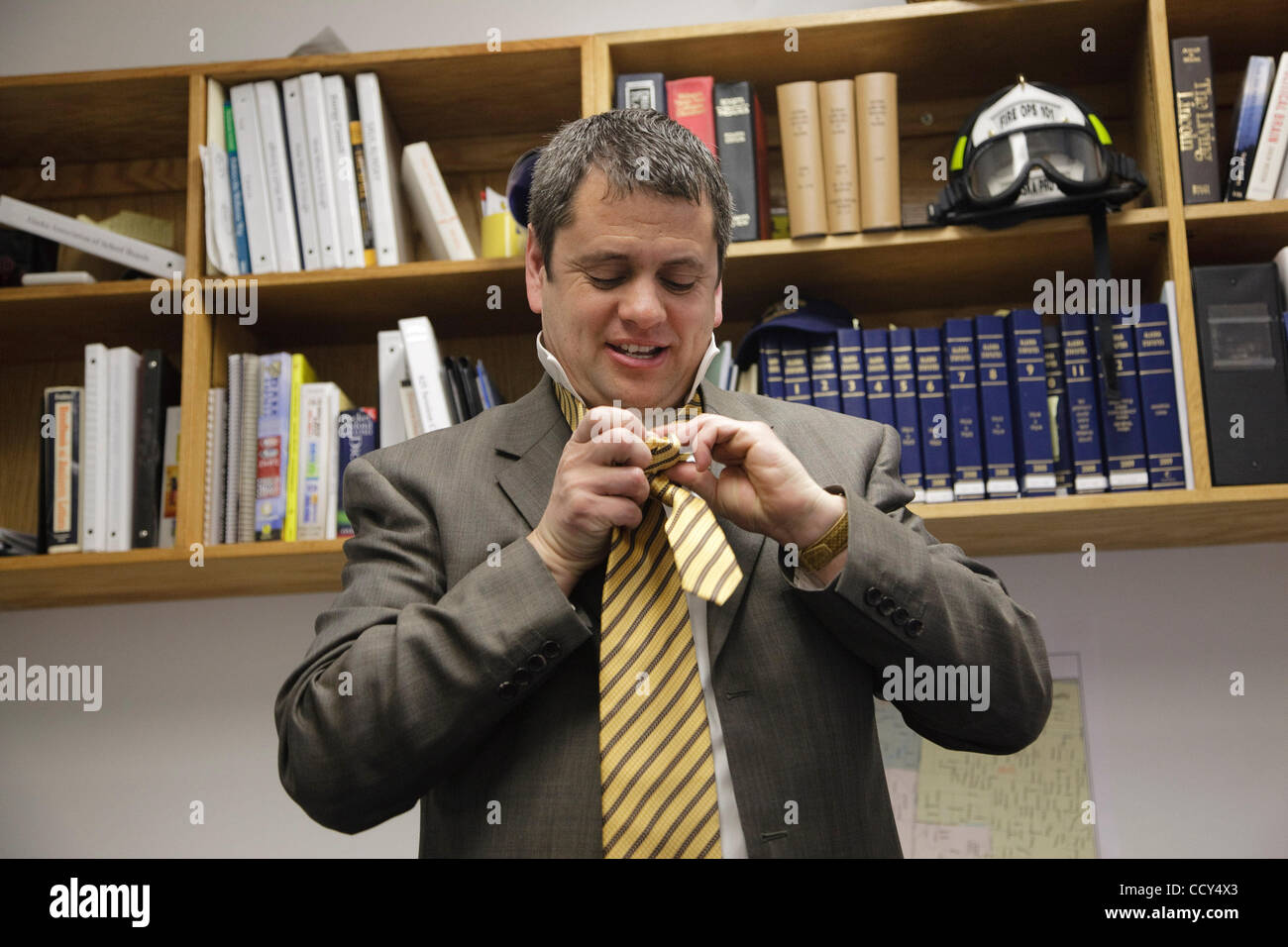 Alaska Representative Chris Tuck (D) changes into his suit in his ...