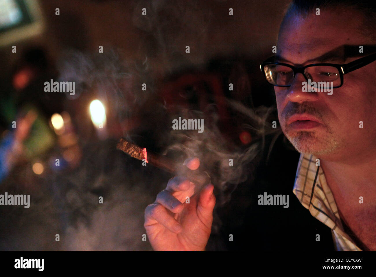 Apr. 18, 2010 - Krakow, Poland - A tourist smokes a cigar a the popular ...
