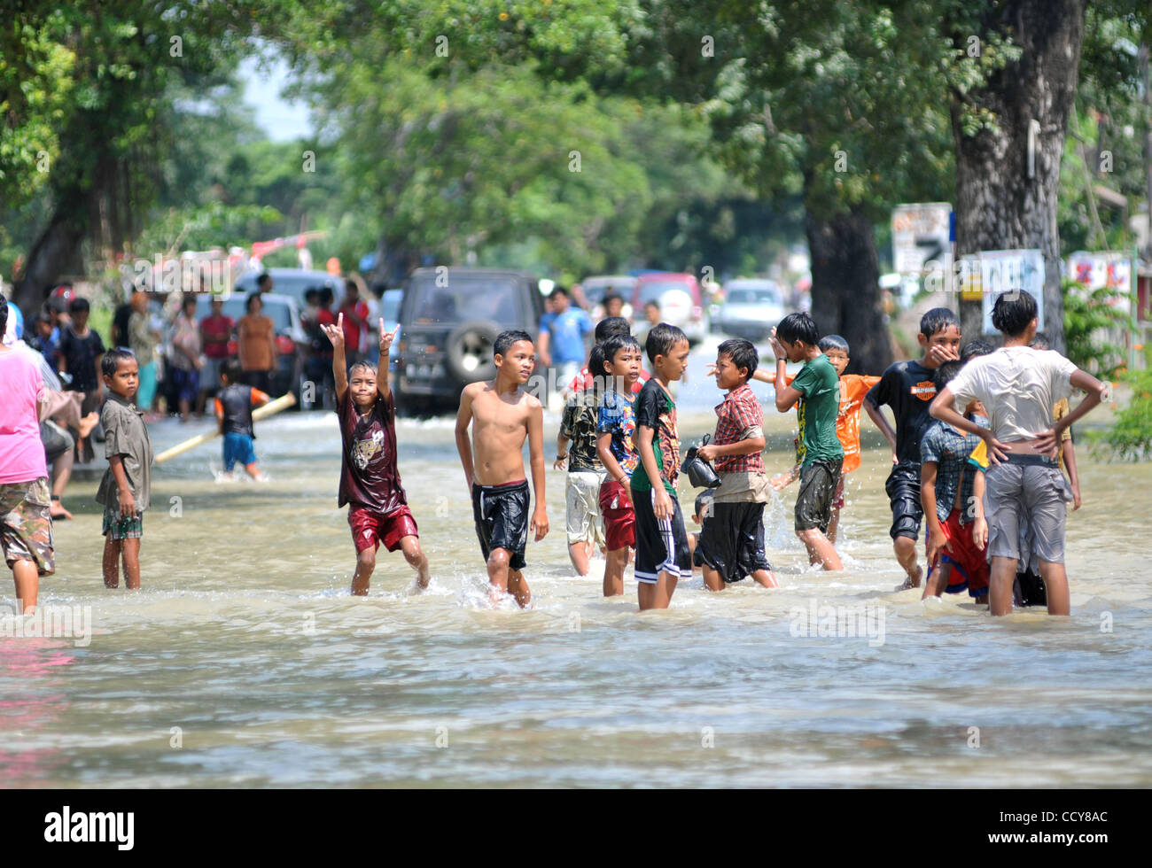 Residents walk through flood water In Karawang, West Java province ...