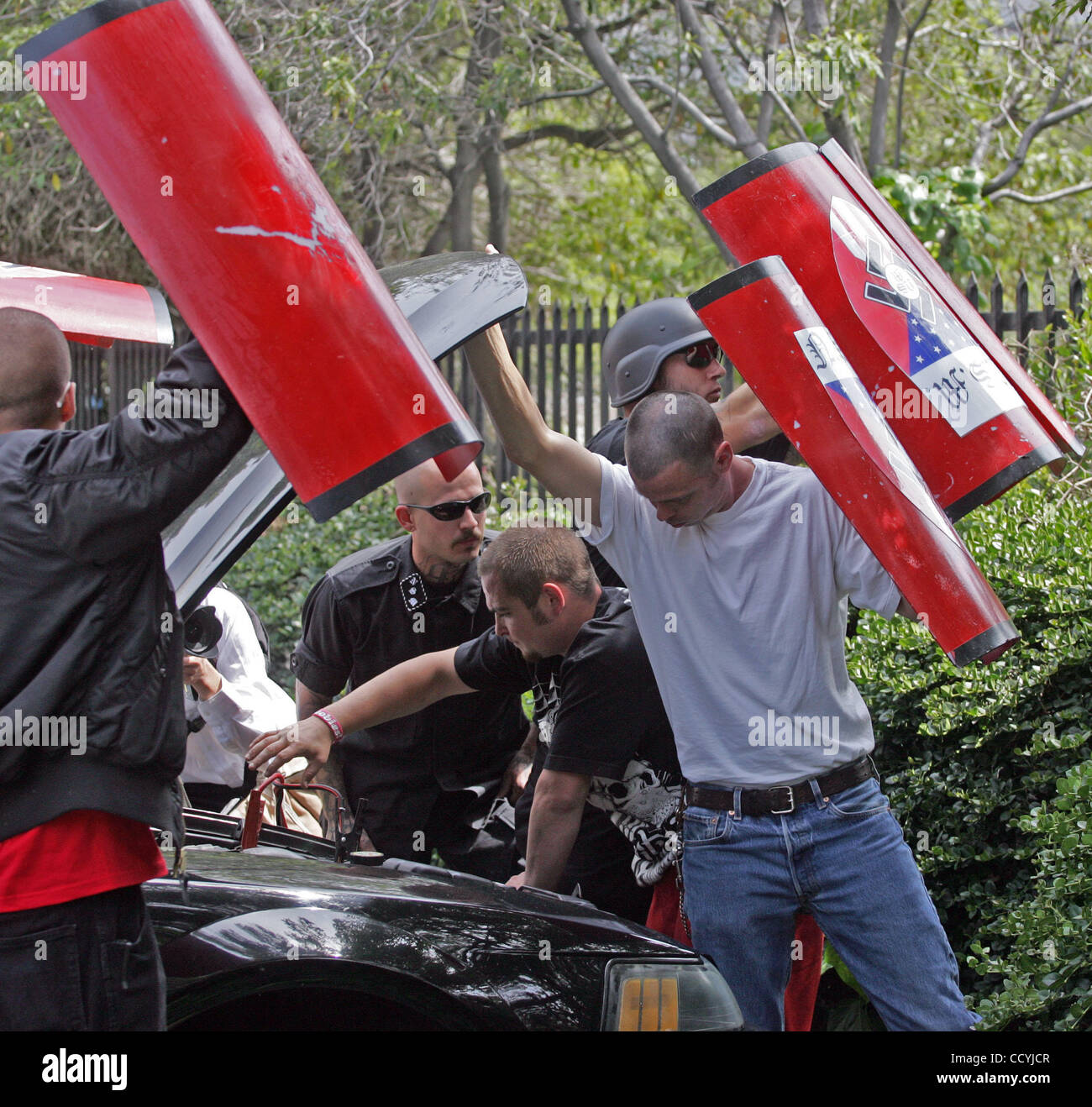 Members of the American National Socialist Movement use shields to ...