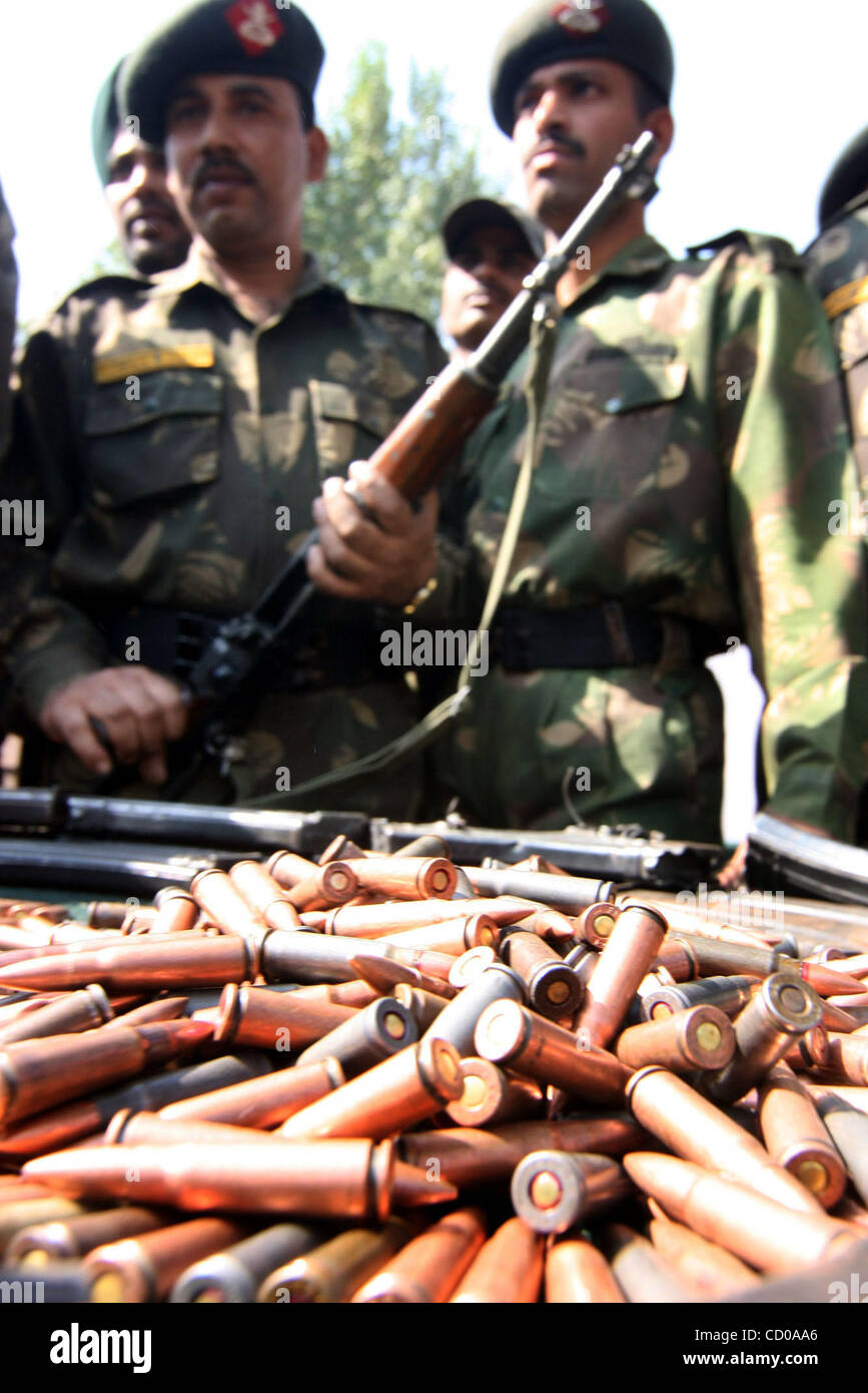 Indian army soldiers and personnel stand behind seized arms after a ...