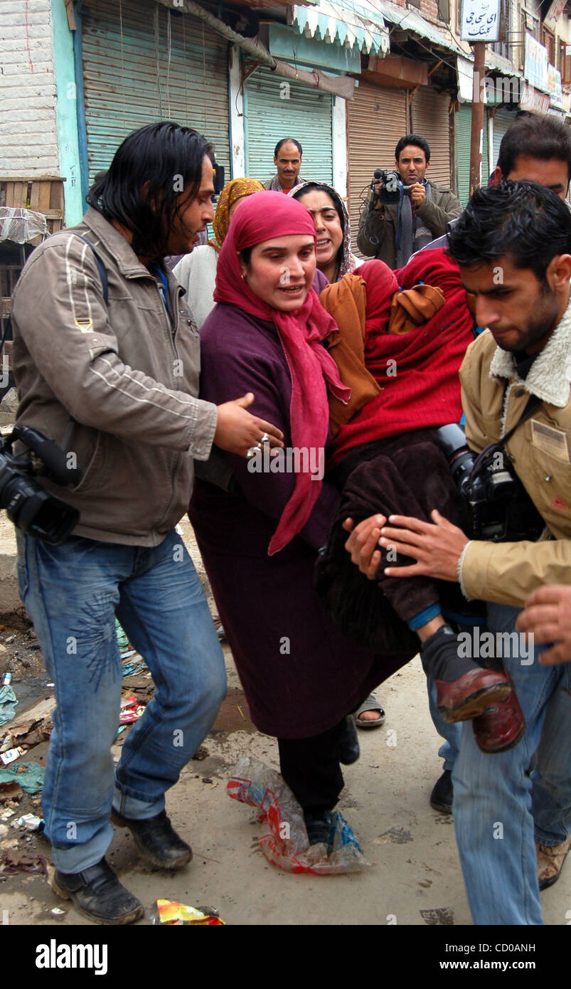 A Kashmiri photo journalists carrying injured woman who was injured on ...