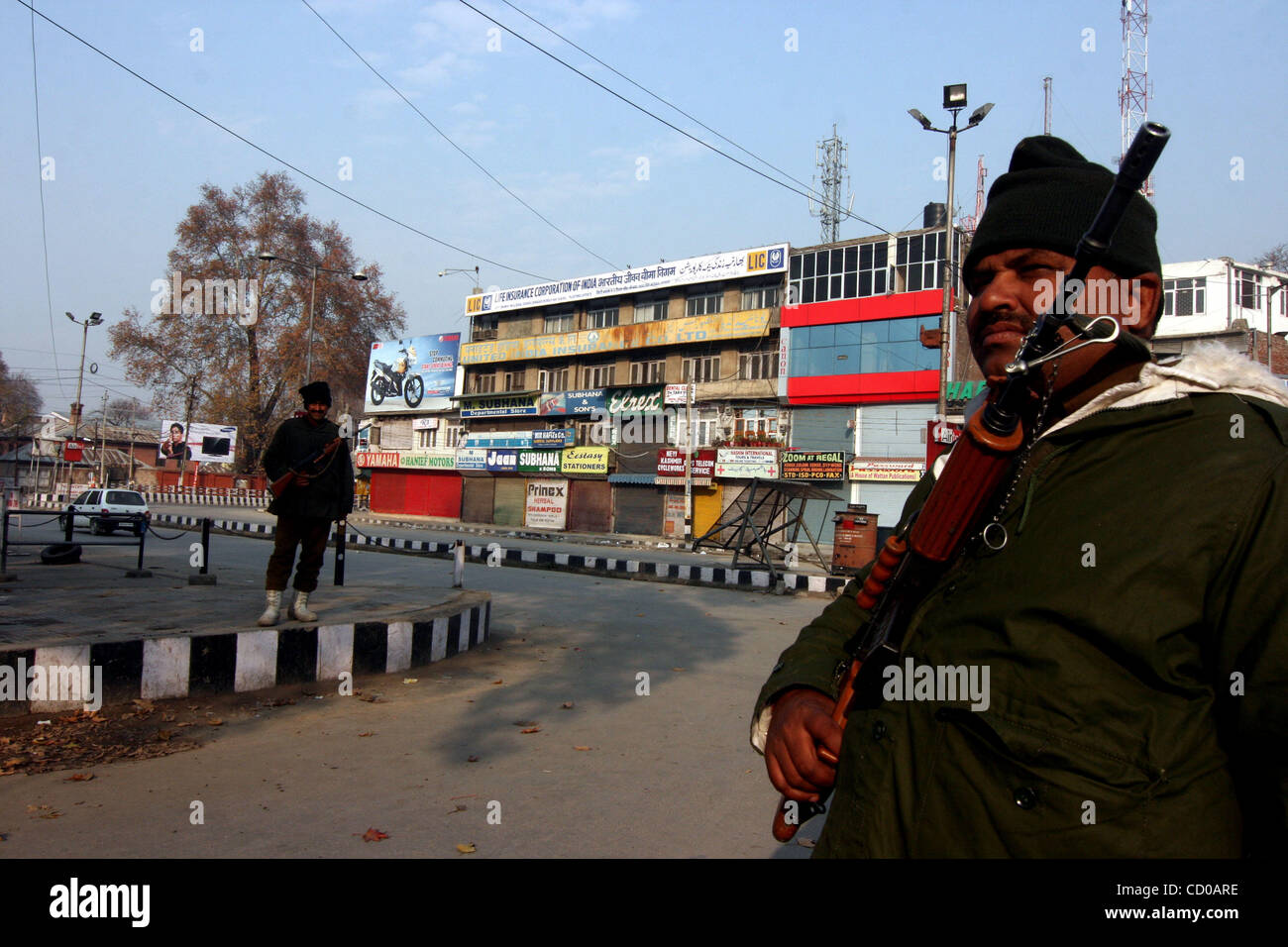 An Indian policeman stands guard during tight security on the eve of ...