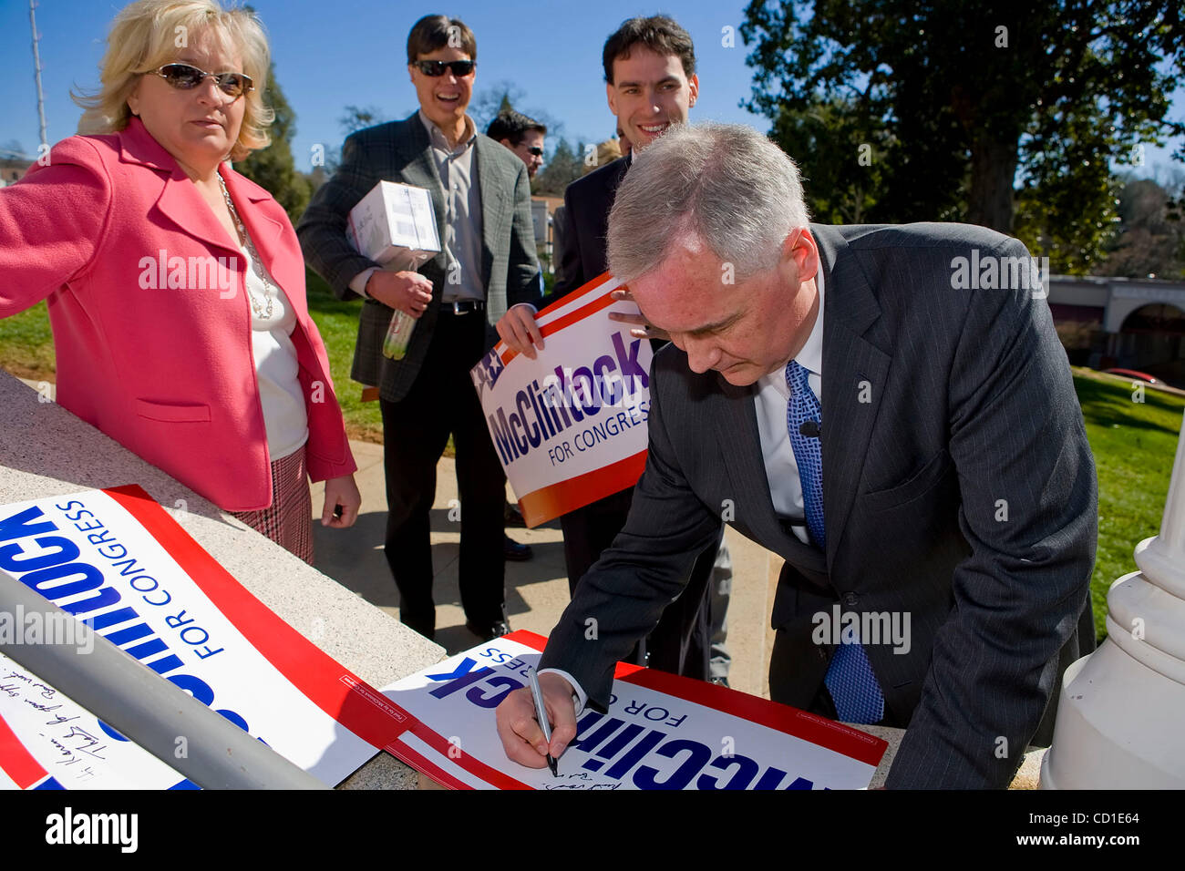 California Senator Tom McClintock signs yard signs after he announced ...