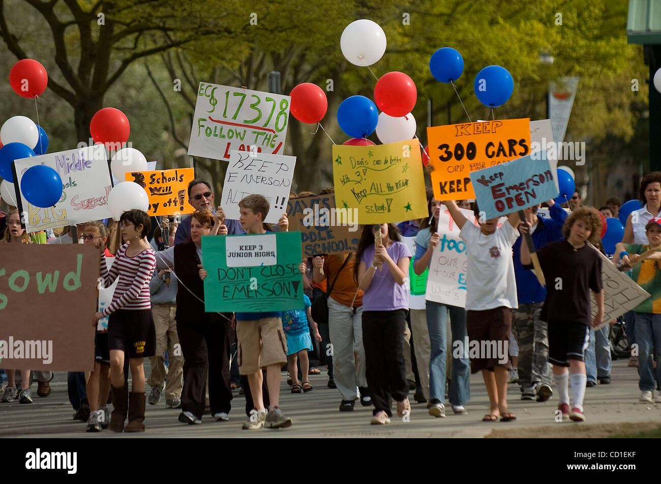 A crowd of demonstrators parades around the block during a ...