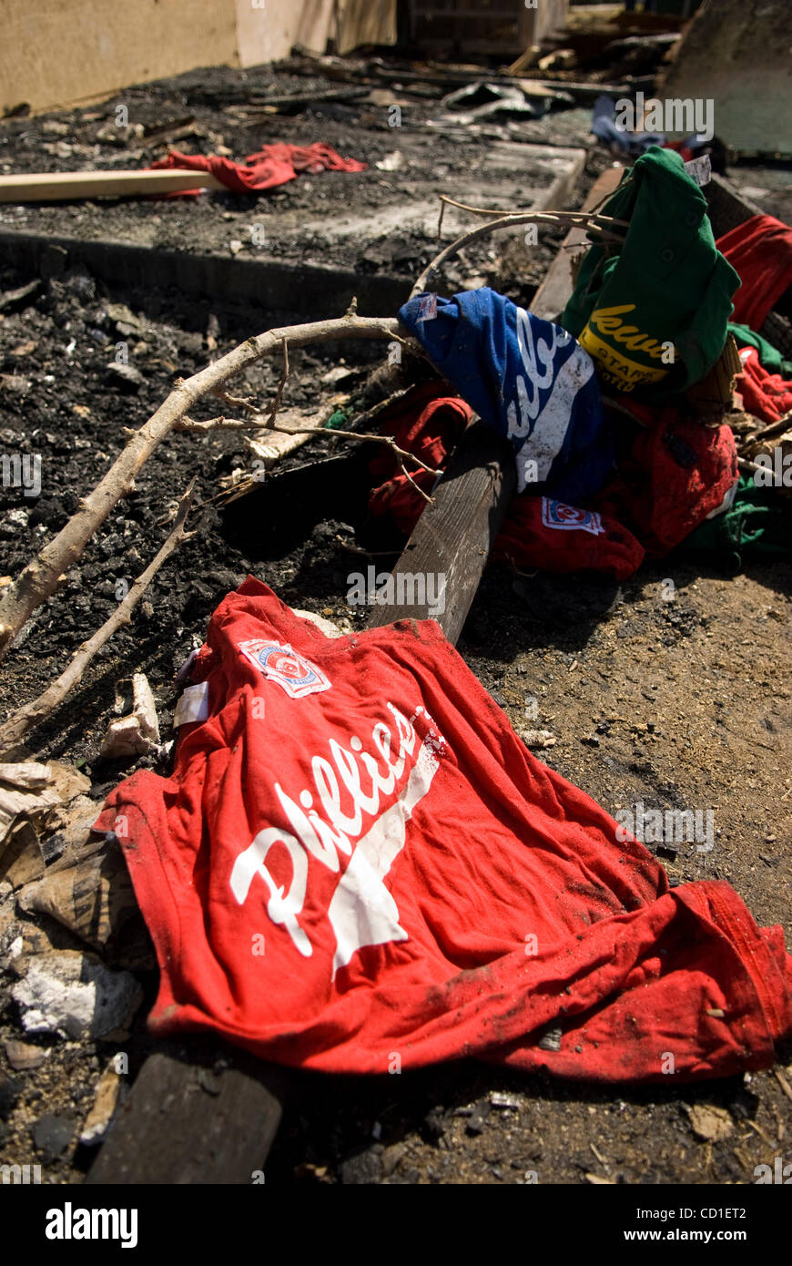 Damaged uniforms lie amongst the wreckage of a Parkway Little League ...
