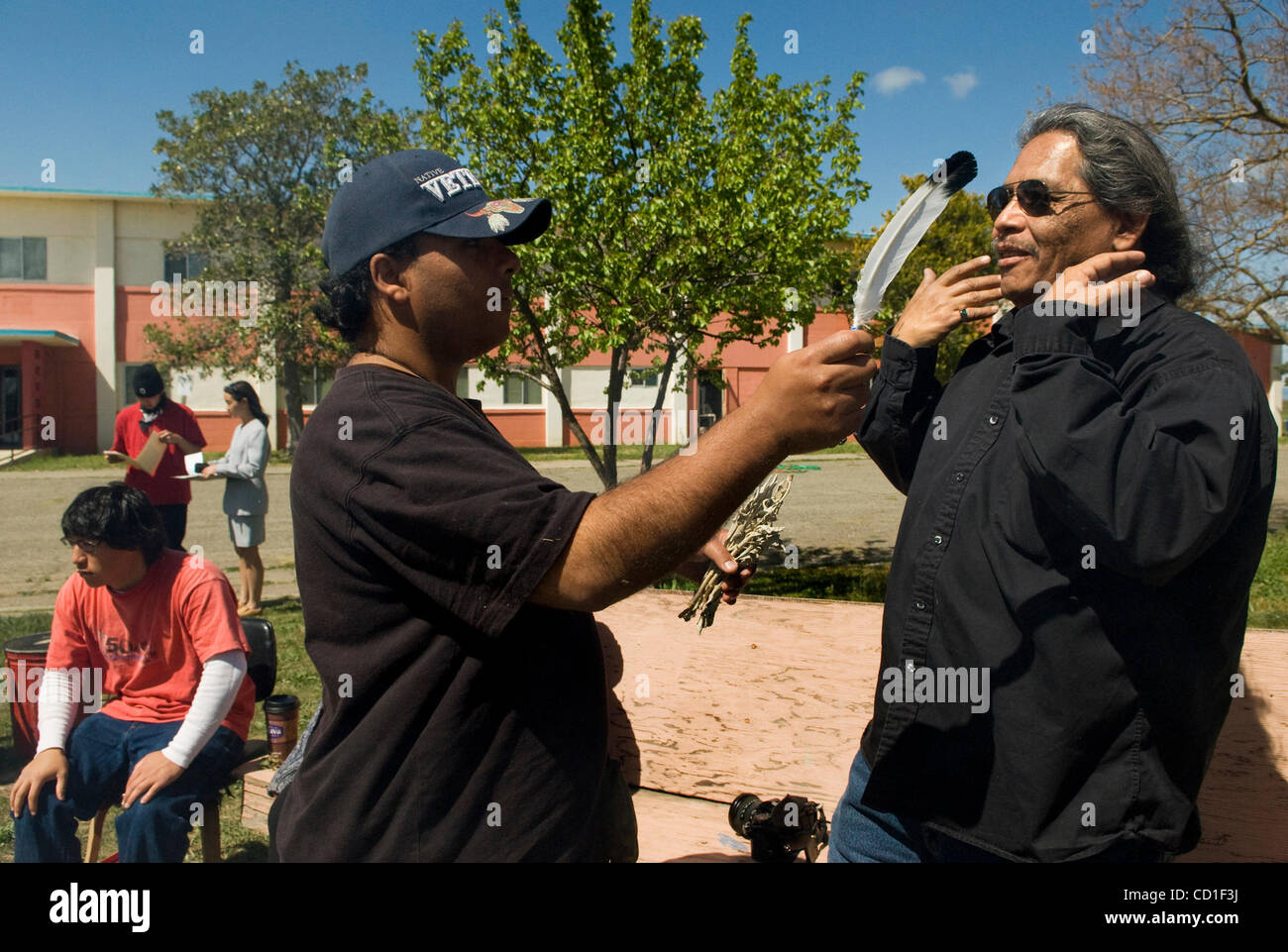 JUMP - Eliase Graywolf of Davis, left, uses a feather to waft purifying ...