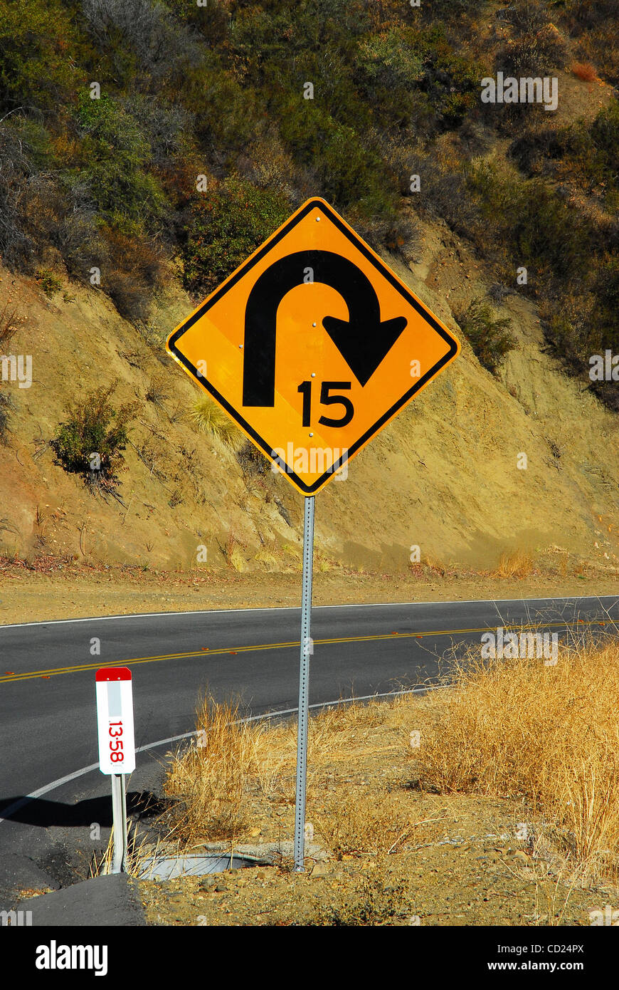 15 MPH Warning Sign Entering The Hairpin Curve Stock Photo - Alamy
