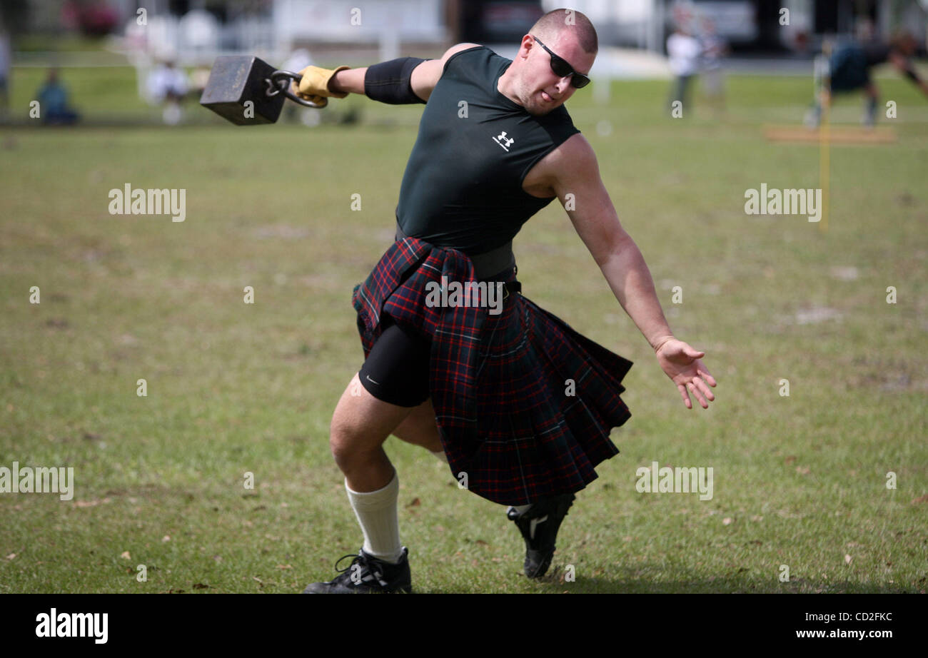 Brian Burnett (cq), 26, practices throwing a 56-lb weight at the Eighth ...