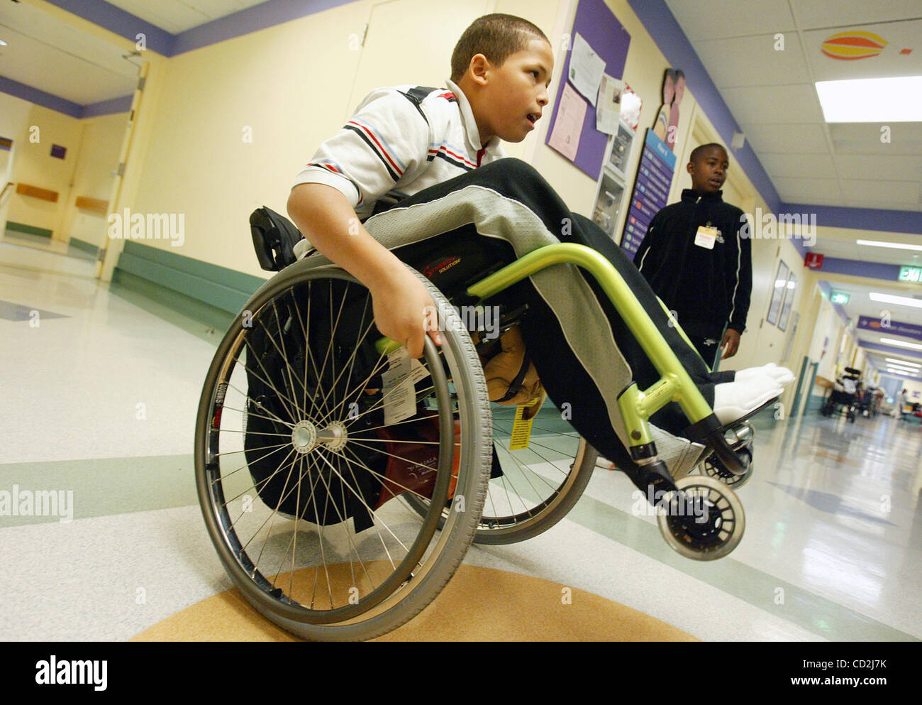 Christopher Rodriquez ,10, does a wheelie down the hall of the fourth ...