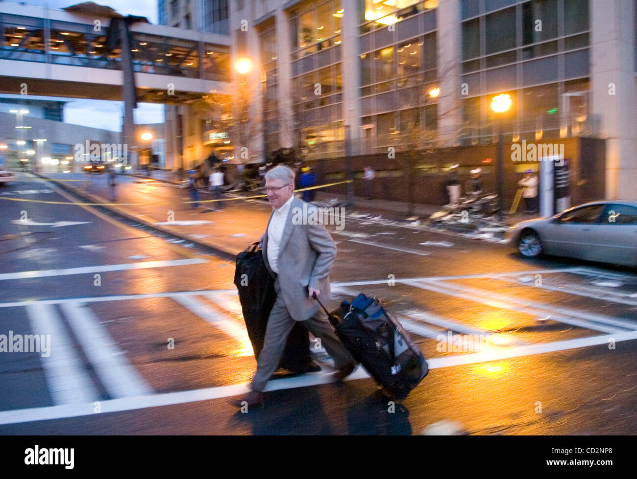 A guest at the Omni Hotel leaves after a powerful tornado swept through ...