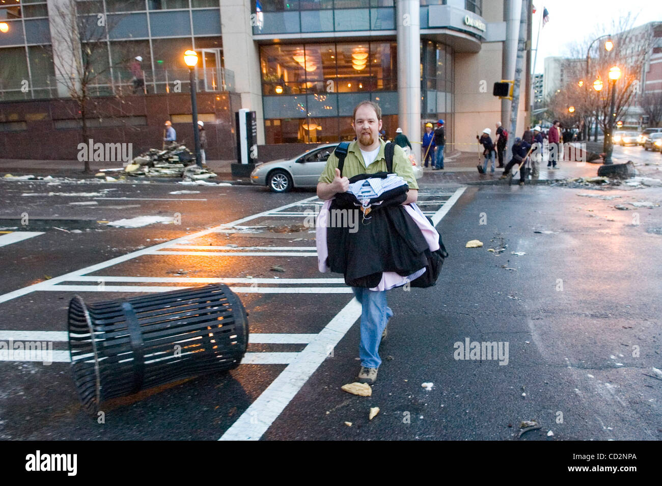 A guest at the Omni Hotel leaves after a powerful tornado swept through ...
