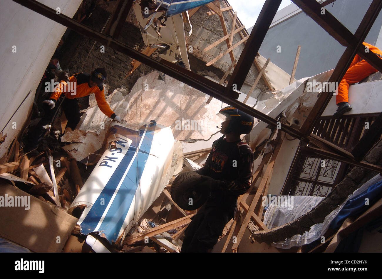 Rescuers search rubble of a house after a plane crashed into a ...