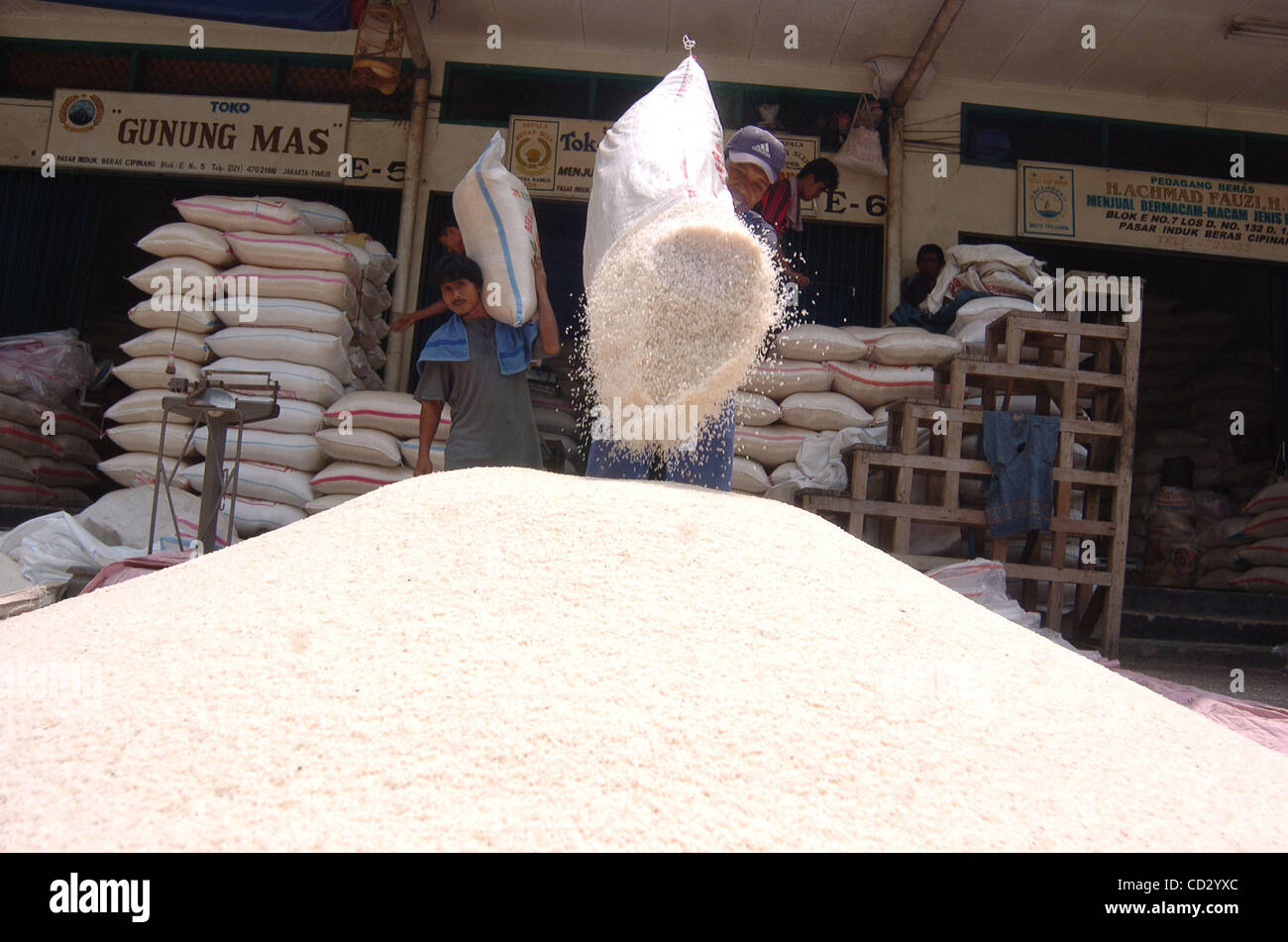 A rice seller prepares rice for sale in Jakarta,Indonesia, March 29 ...