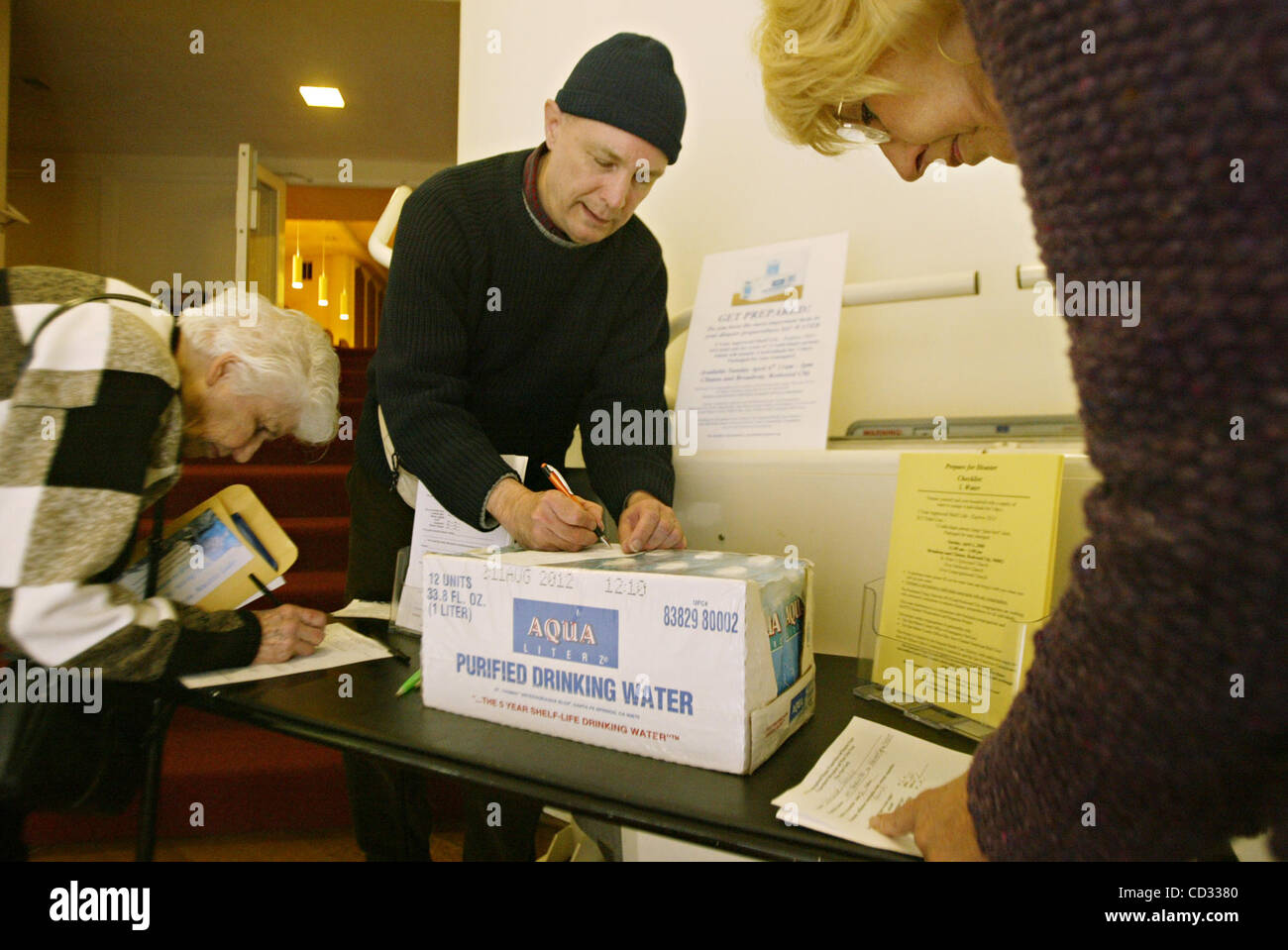 Jim Johnson of United Methodist Church helps Ann Marie Sulzbach, right ...