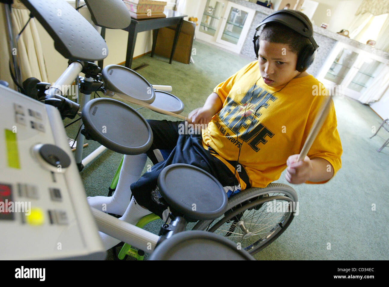 Chris Rodriguez plays his electric drum set in his family's home on ...