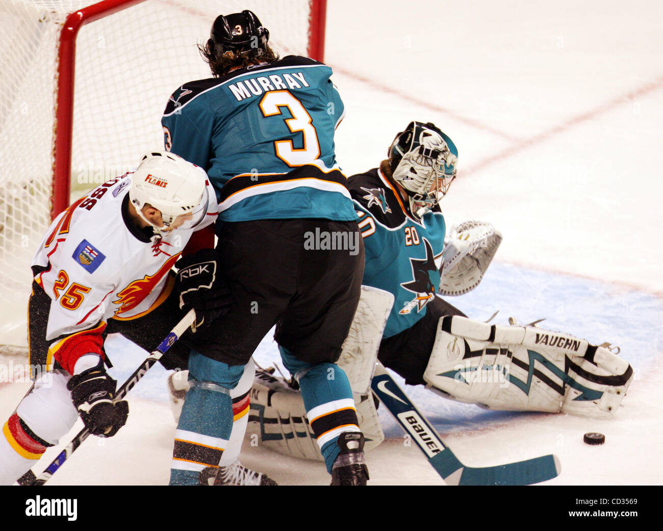 Sharks goalie Evgeni Nabokov attempts to block a shot by Calgary's ...
