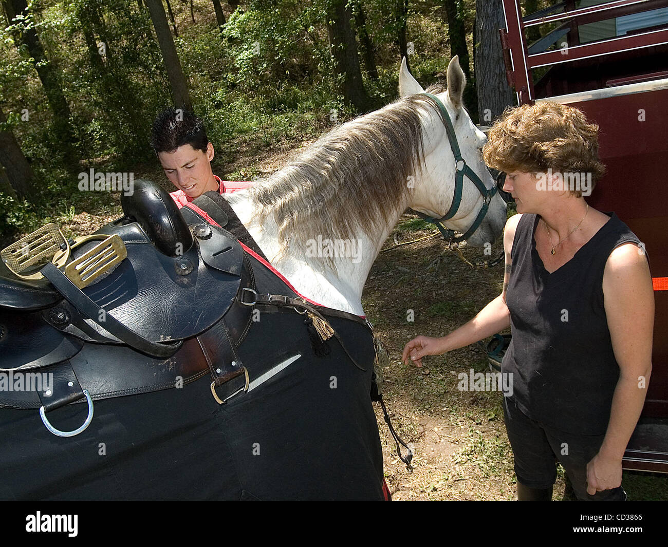 Trish Mack, right, helps Jack Cowan prepare his horse Cutter for the ...