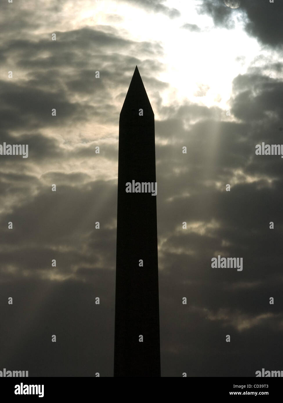 The Washington Monument is silhouetted against the setting sun in ...