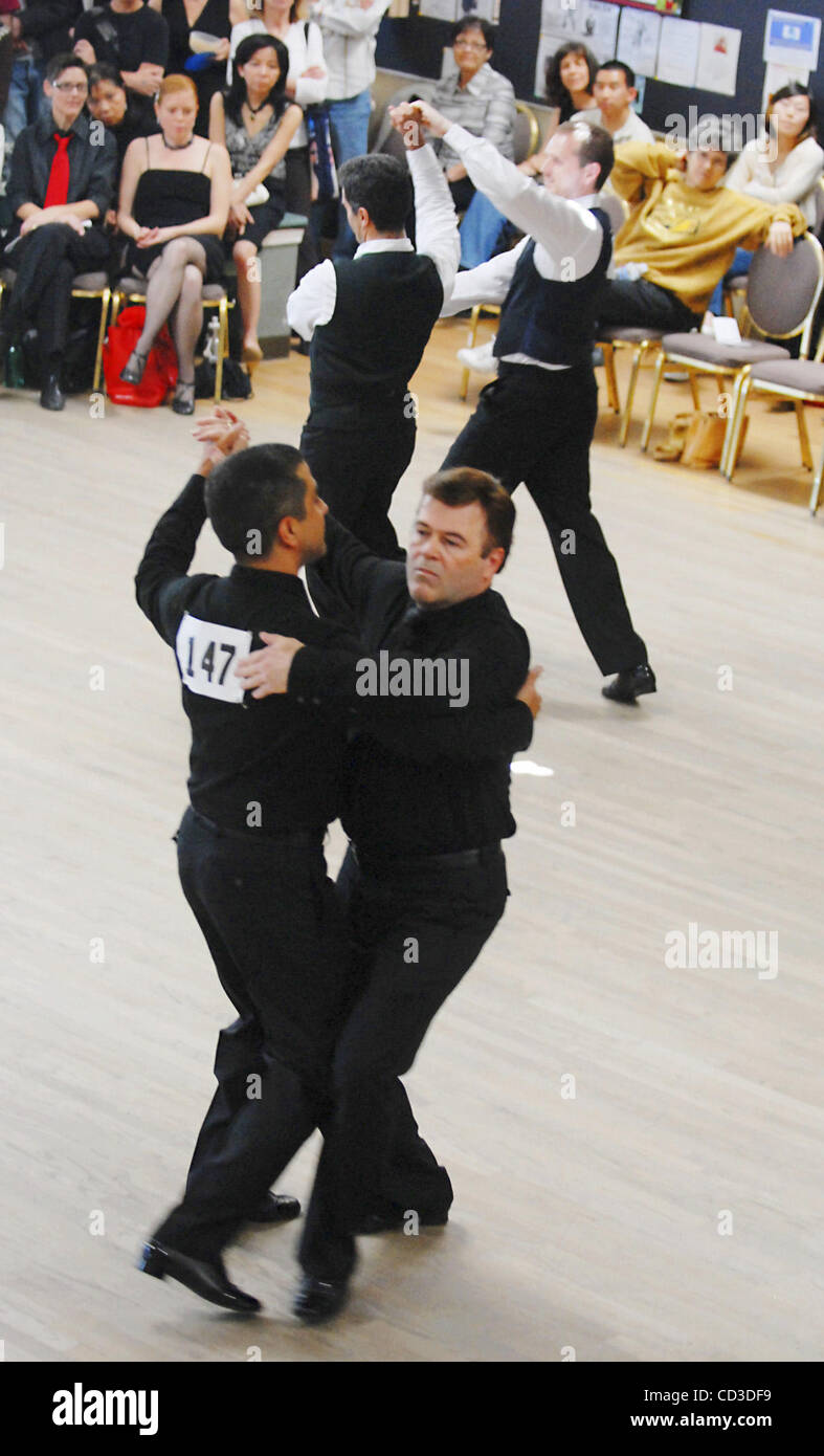 At foreground, Mark Nunez and his partner concentrates as they dance ...