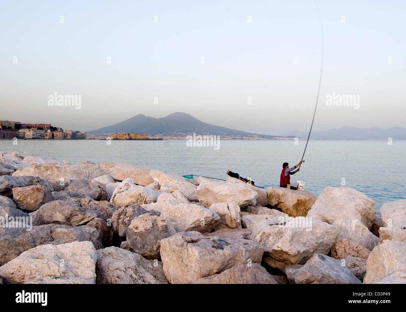 May 26, 2008 - Naples, Italy - A man fishes in the Bay of Naples along ...