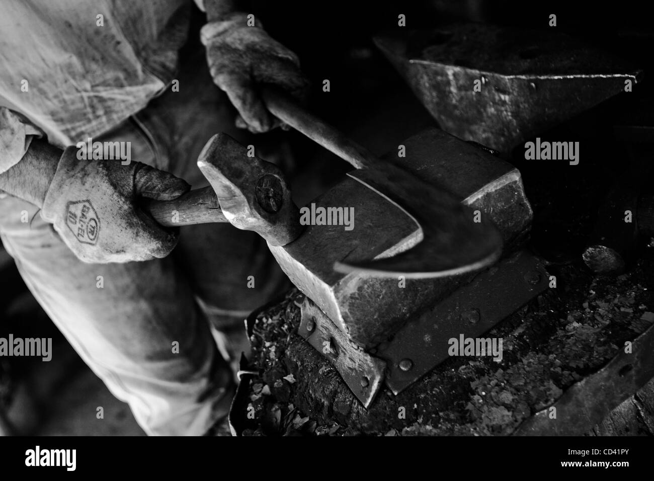 July, 10, 2008 - Diyarbair, Turkey - Using a hammer and anvil ...