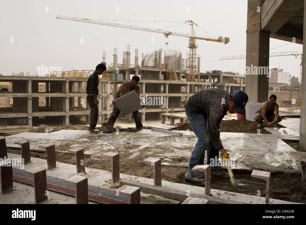 Jul 16, 2008 - Arbil, Iraq - Construction workers install flooring on ...