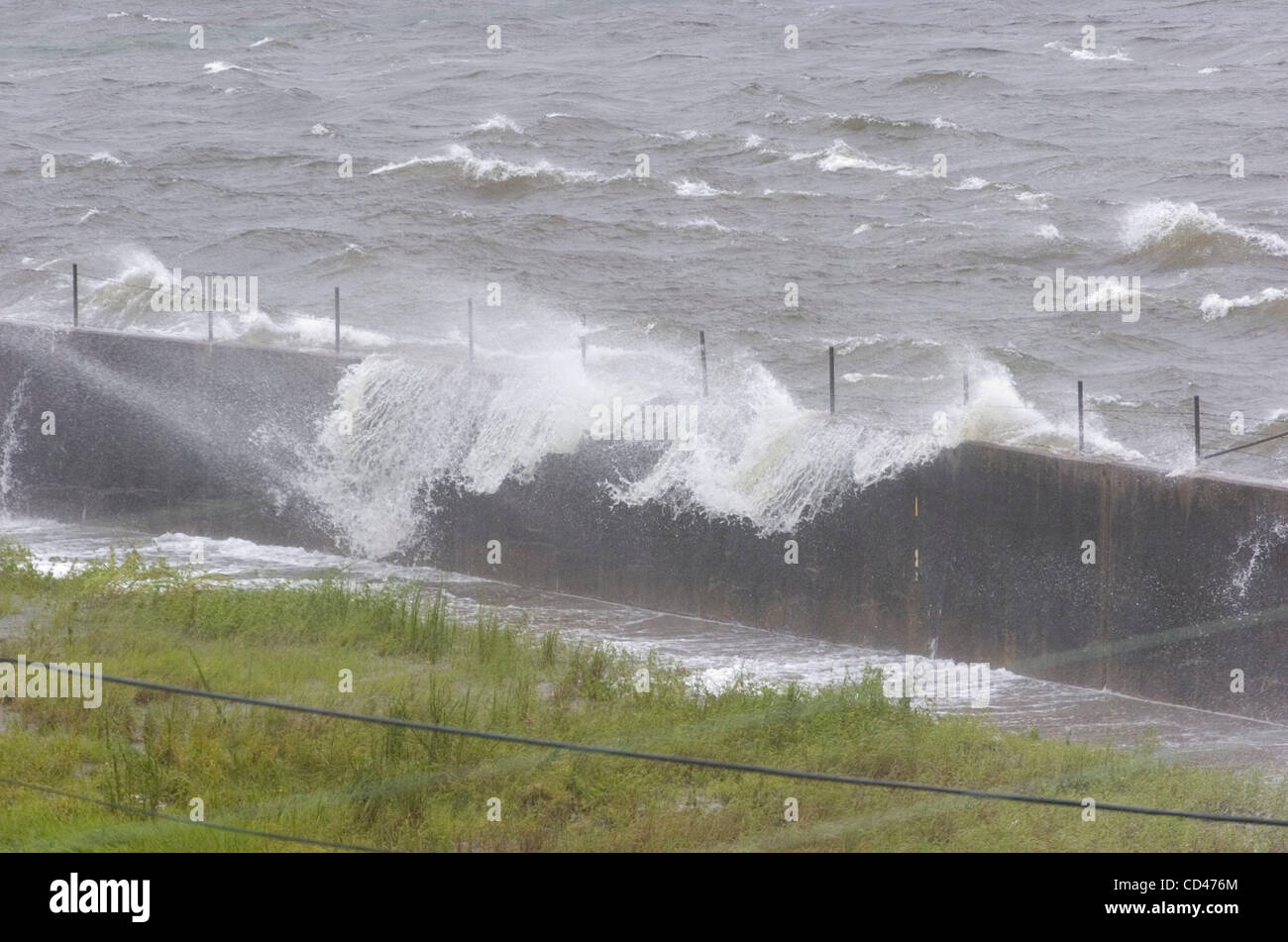 Wind driven water laps over a flood wall along the Inner Harbor ...