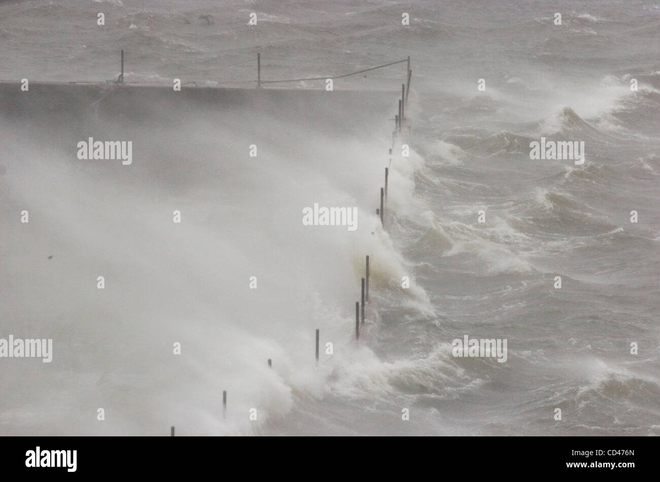 Wind driven water laps over a flood wall along the Inner Harbor ...
