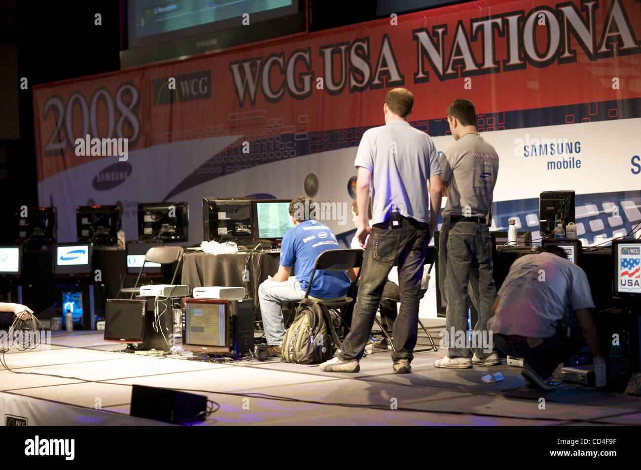 Team members look on during a video game competition during "E for All ...
