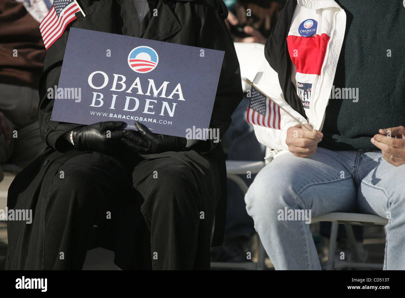 Guest of an Barak Obama and Joe Biden rally hold Obama and Biden signs ...