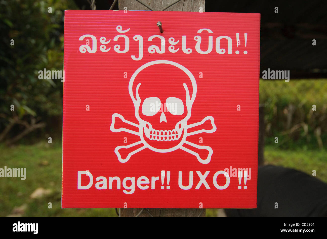 Un exploded ordnance sign at UXO Laos Bomb disposal organisation's ...
