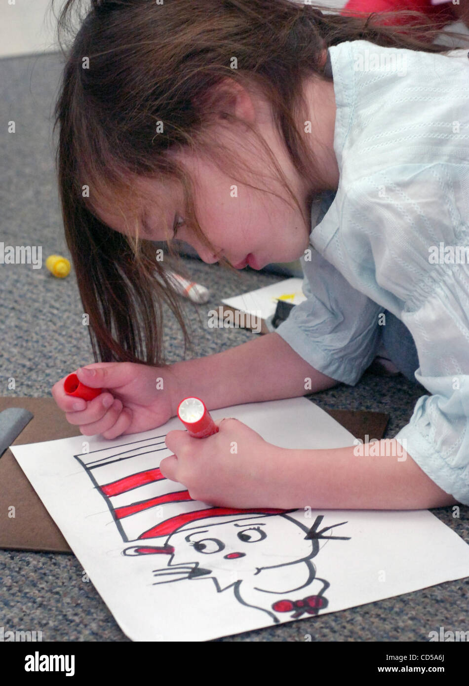 First grader Trinity Olman colors in her drawing of Dr. Seuss books, in ...