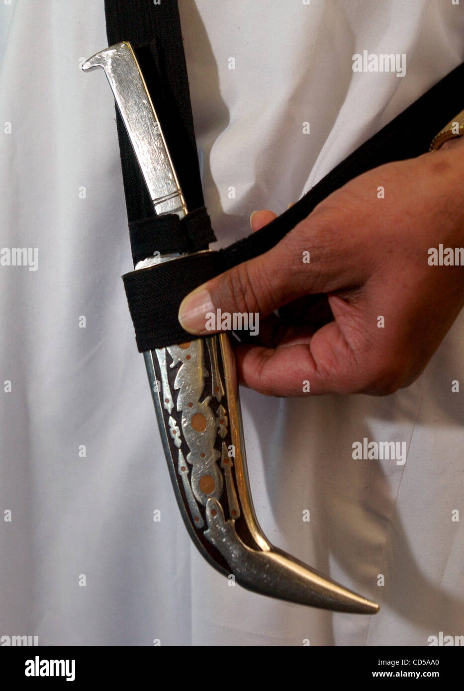 Head priest Makhan Singh wears his kirpaan, a ceremonial knife, as he ...