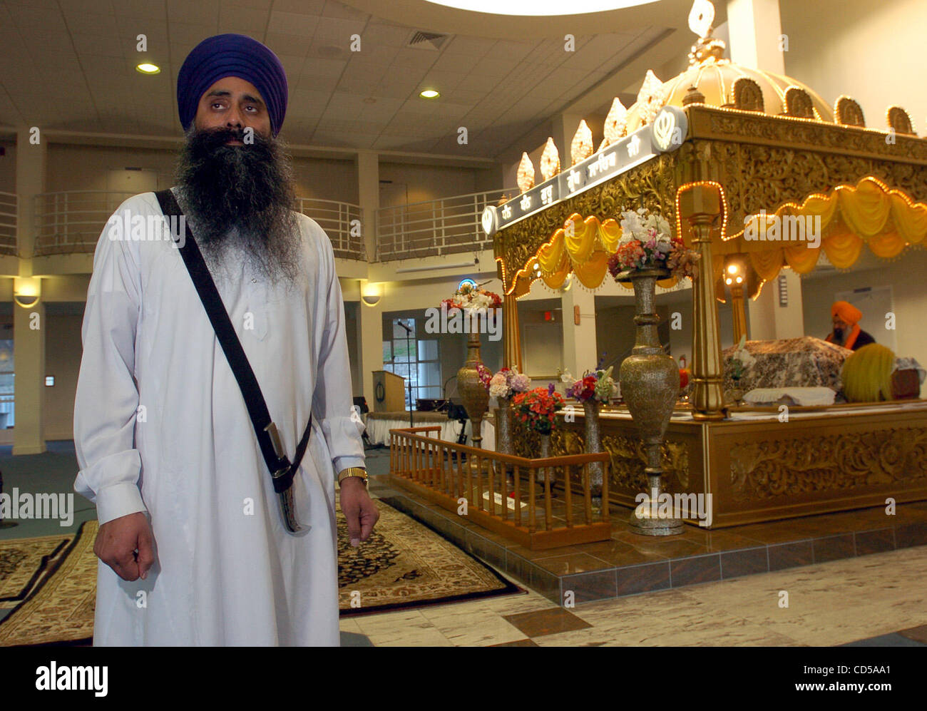Head priest Makhan Singh wears his kirpaan, a ceremonial knife, as he ...