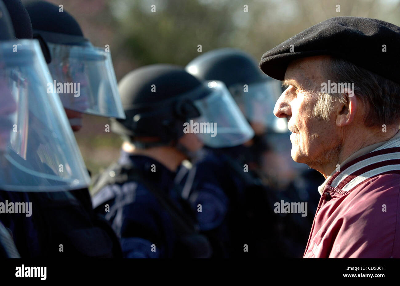 A nuclear weapons protester stands and stares as members of the ...