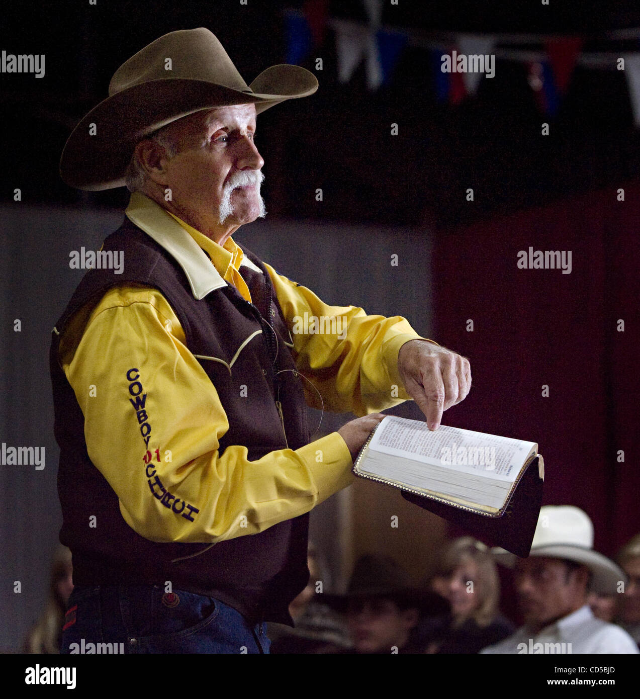 Cowboy preacher Coy Huffman points to his bible during a church service ...