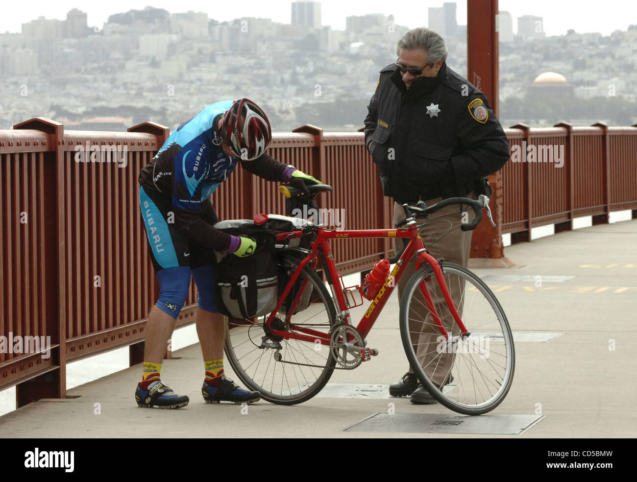 A Golden Gate Bridge patrol officer checks out a cyclist near the north ...