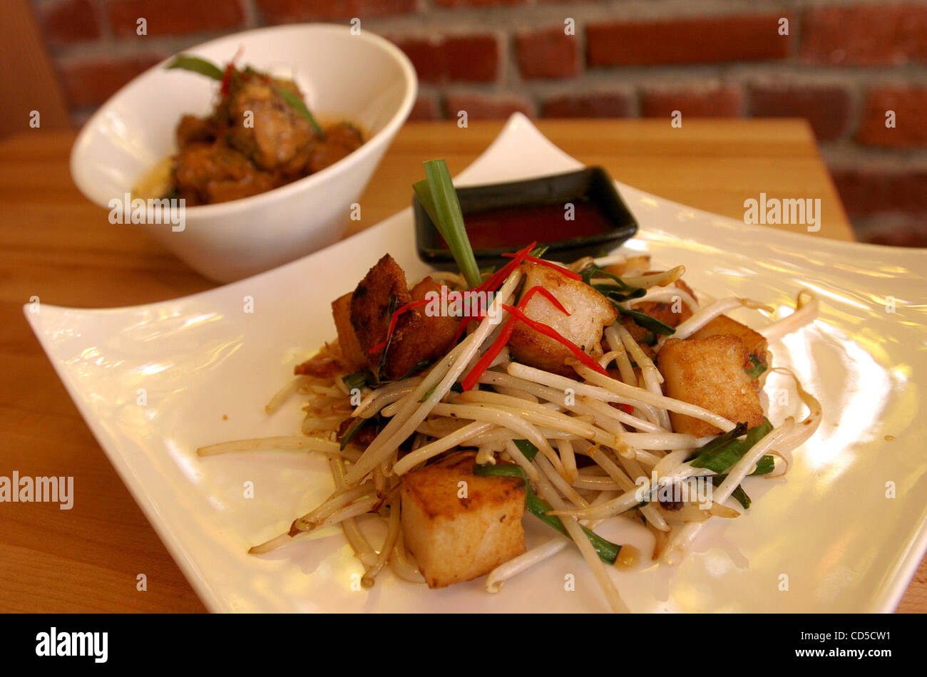 The kanom pak kard (front), a radish cake appetizer, with bean sprouts ...