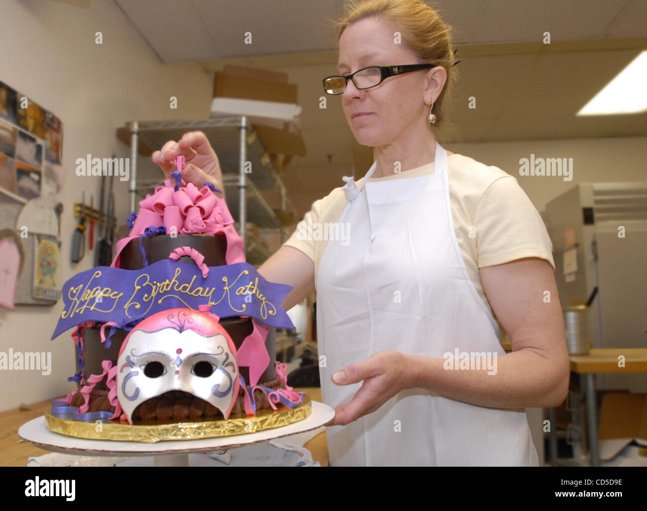 Katrina Rozelle Topp of Katrina Rozelle bakery puts the finishing ...