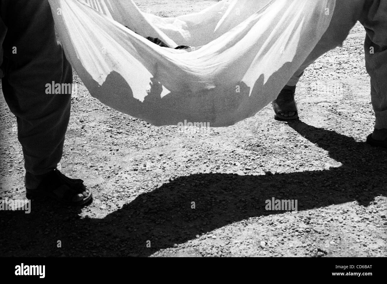 May 24, 2003 - Al-Musayab, Iraq - The Iraqi exhumation team carries ...